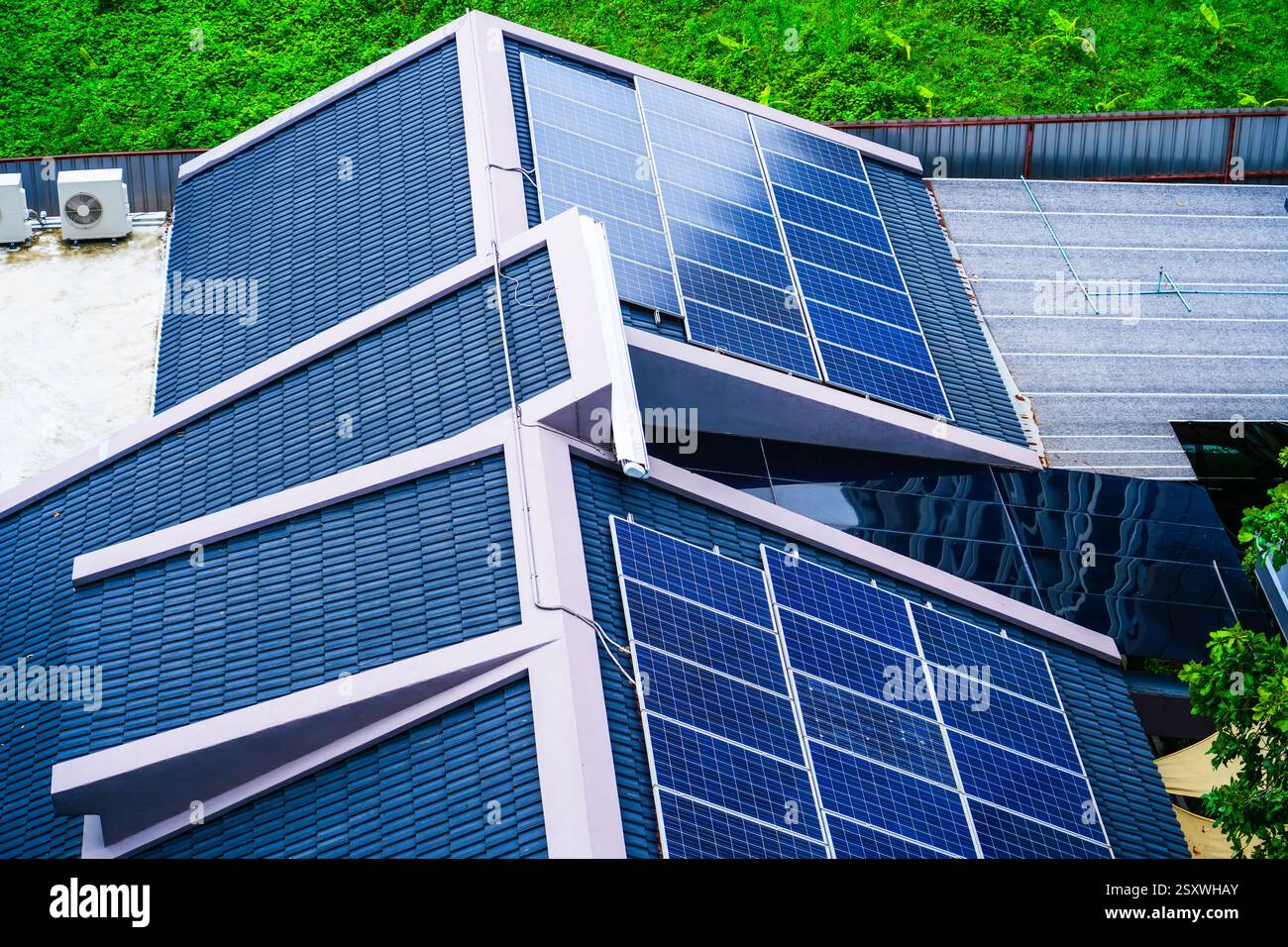 Rooftop solar panels gleam under the bright sunlight, contributing to ...