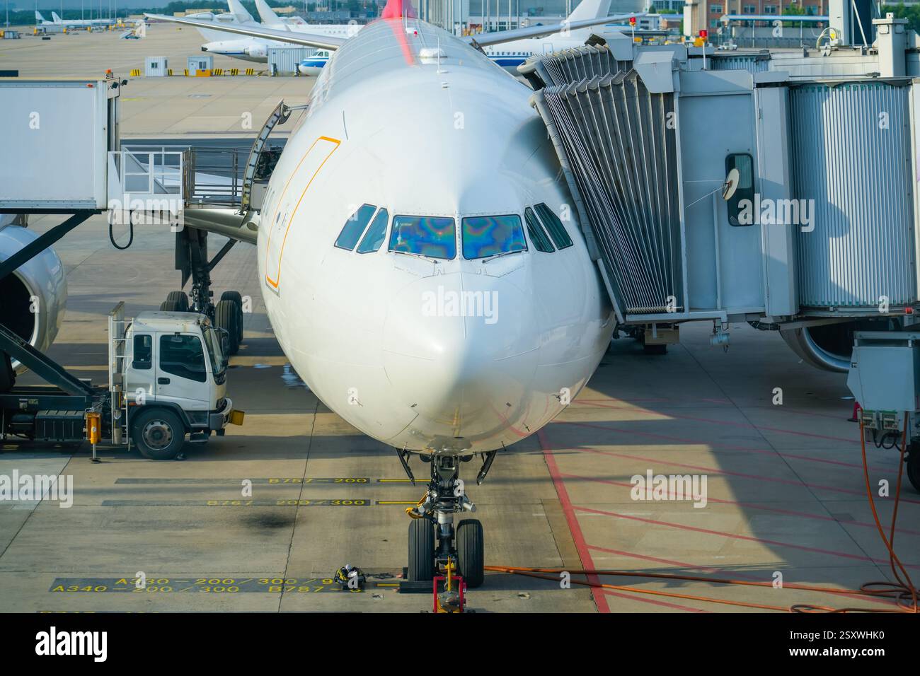 View of the front landing gear and cockpit straight ahead and the docking gangway air bridge ...