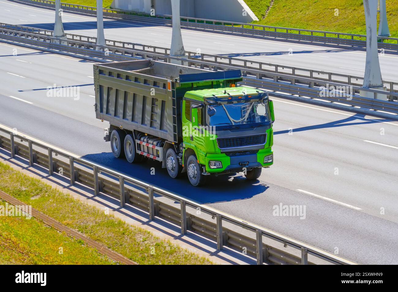Truck huge dump green truck heavy bulk cargo drives fast along the ...