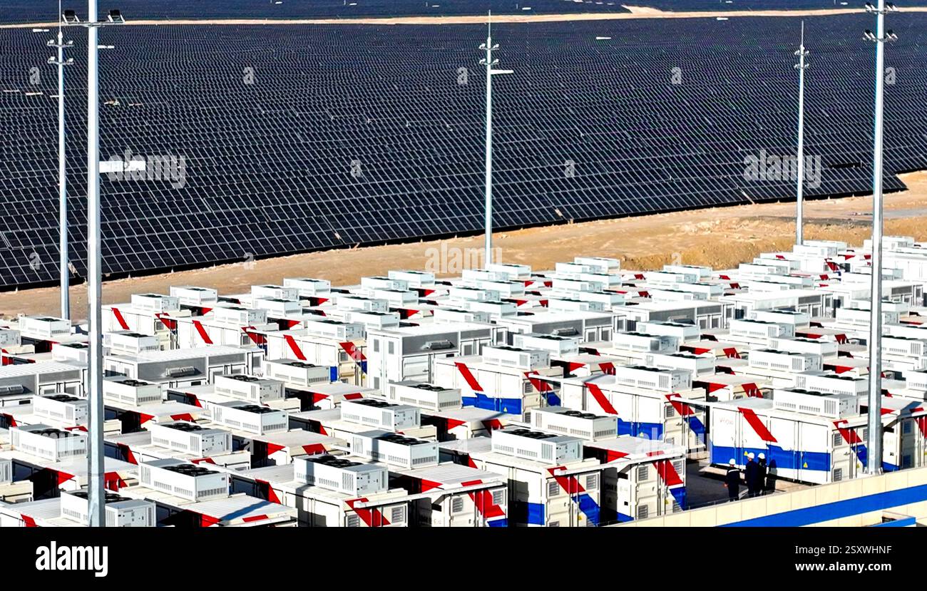ZHANGYE, CHINA - FEBRUARY 25, 2025 - Technicians install and test ...