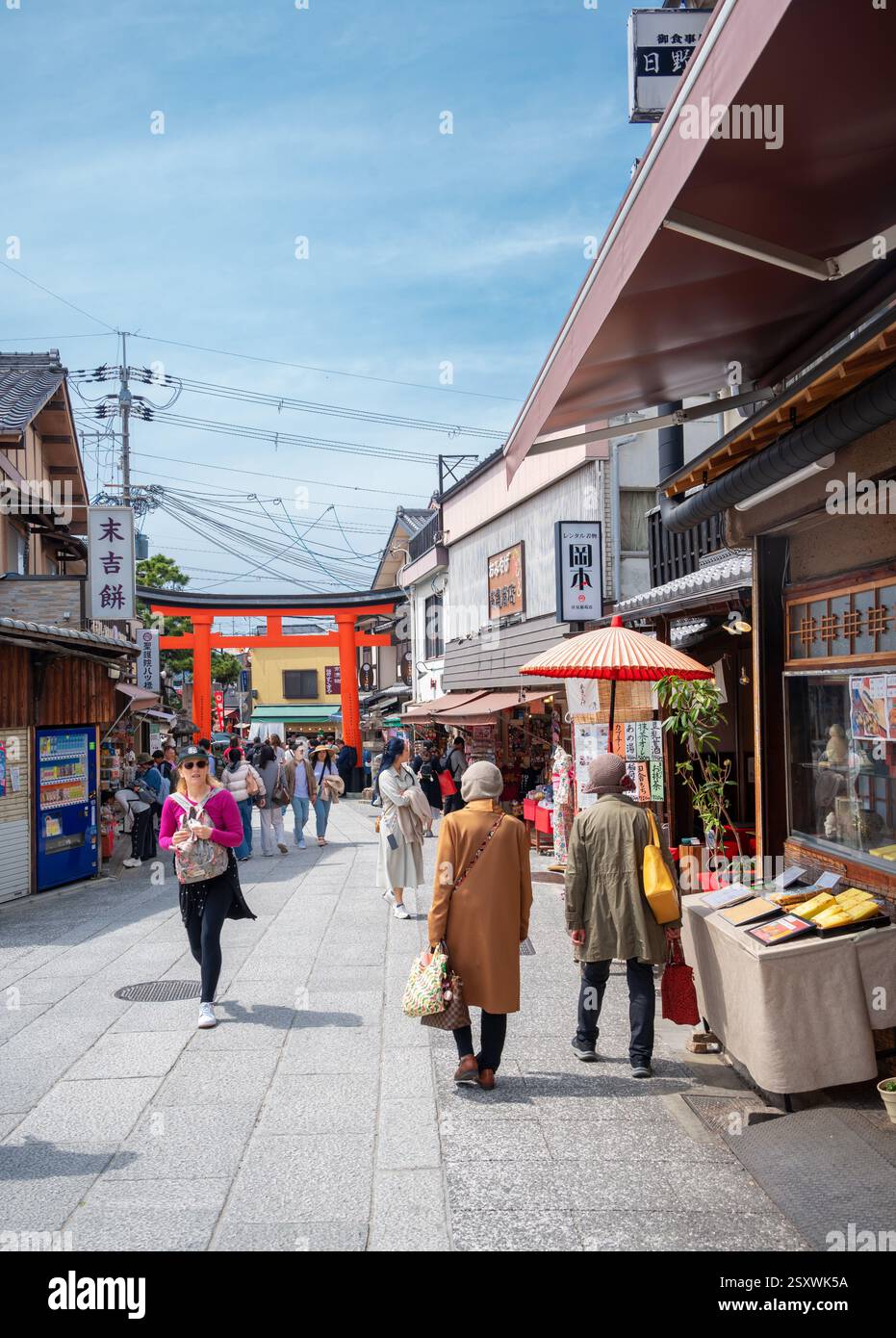 Tourists enjoy Japanese local delicacies in stalls outside the Fushimi ...