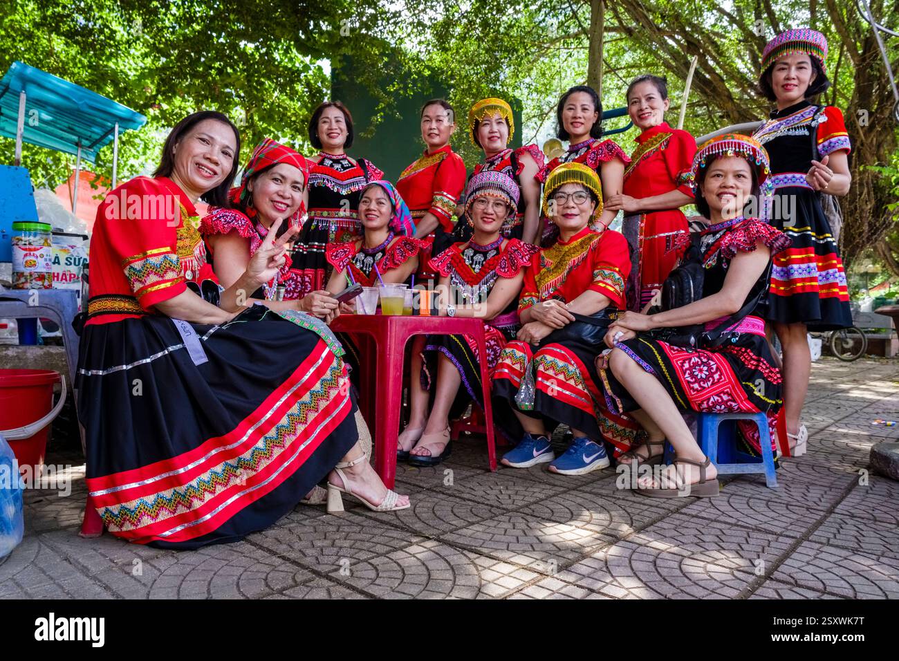 A group of Hmong women in traditional dress visit the weekly market in ...