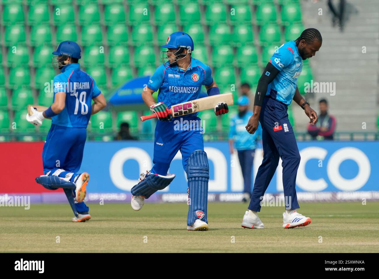 Afghanistan's Rahmanullah Gurbaz, center, and Ibrahim Zadran, left, run between the wickets as ...