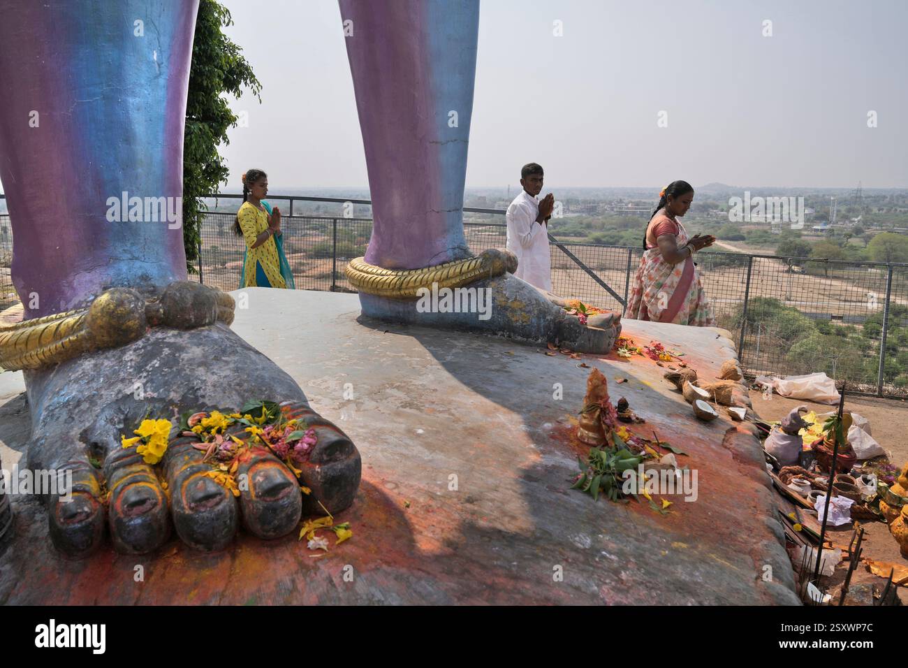 Hindu devotees pray at a giant statue of Lord Shiva during Shivaratri ...