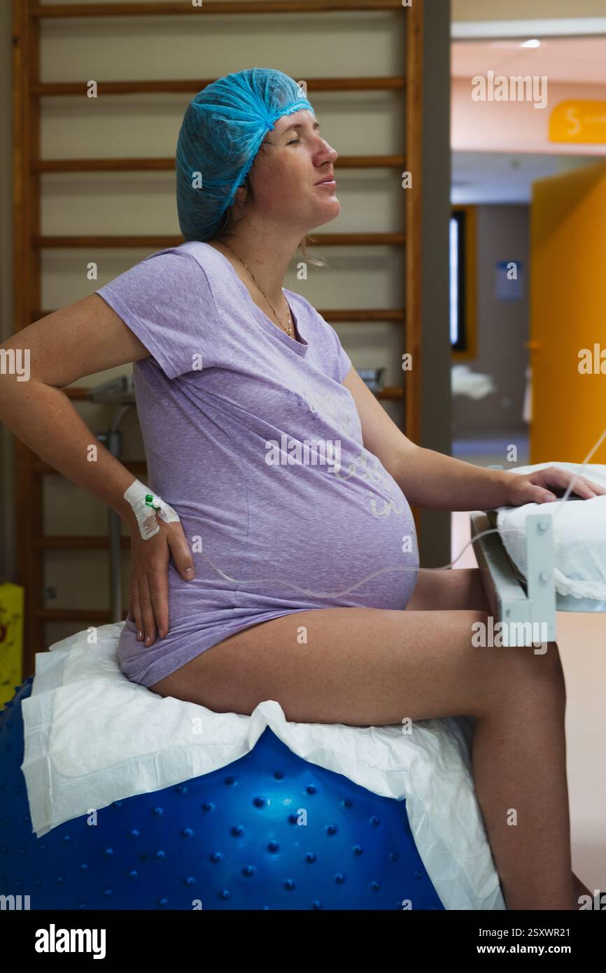 A touching moment of childbirth in a hospital. Doctors and staff assist ...