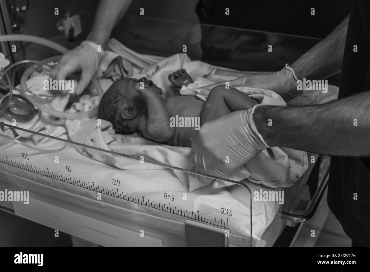 A touching moment of childbirth in a hospital. Doctors and staff assist ...