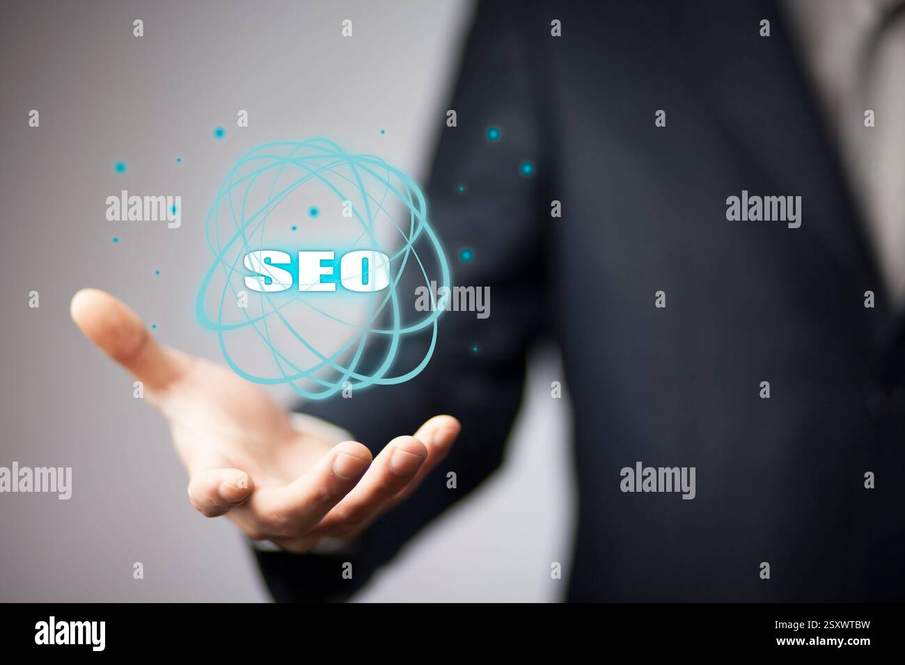 Business man holding SEO text on screen Stock Photo - Alamy