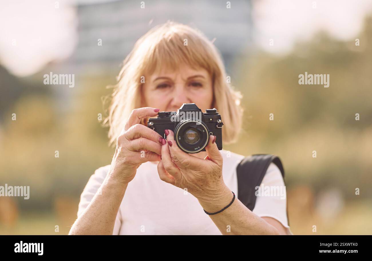 Using the camera. Making the photos. Senior woman having nice weekend ...