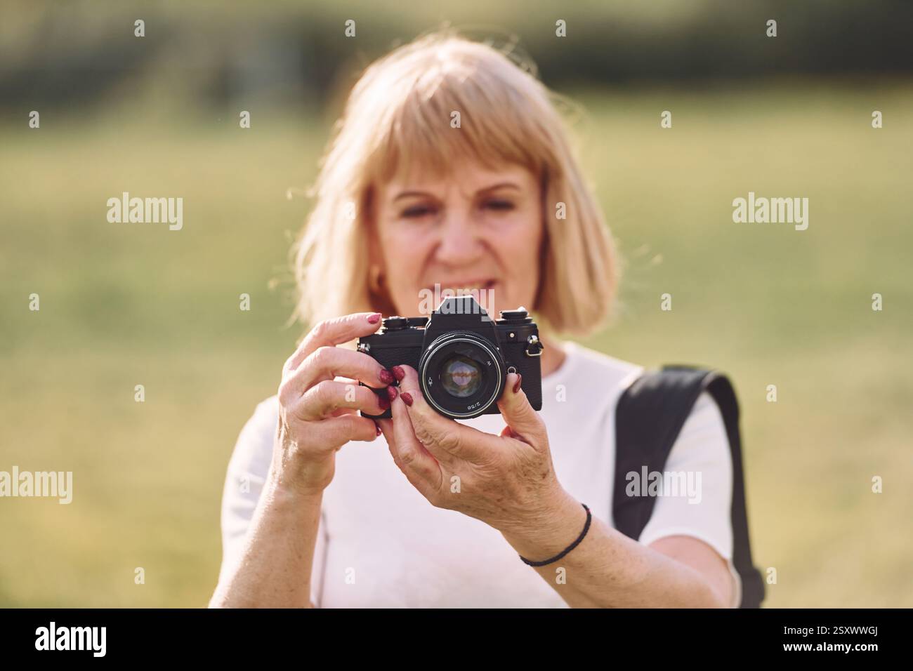 Using the camera. Making the photos. Senior woman having nice weekend ...