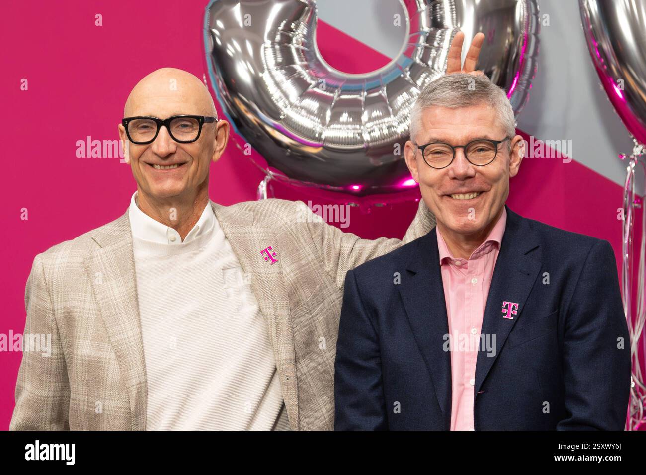 Tim Höttges L, CEO der Deutsche Telekom AG, hebt seine Finger hinter ...