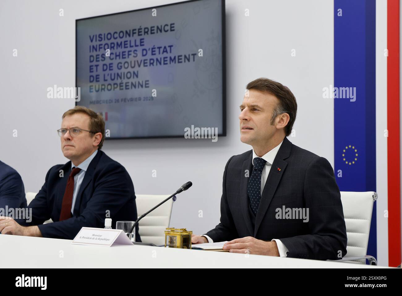 French President Emmanuel Macron, right, holds a video meeting ...