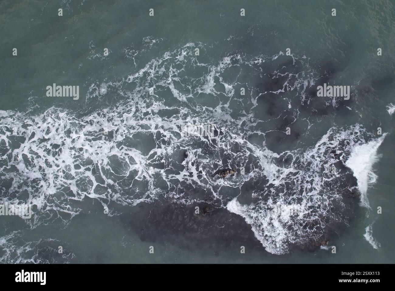 Aerial captures at the shoreline of Downderry beach in Cornwall UK ...