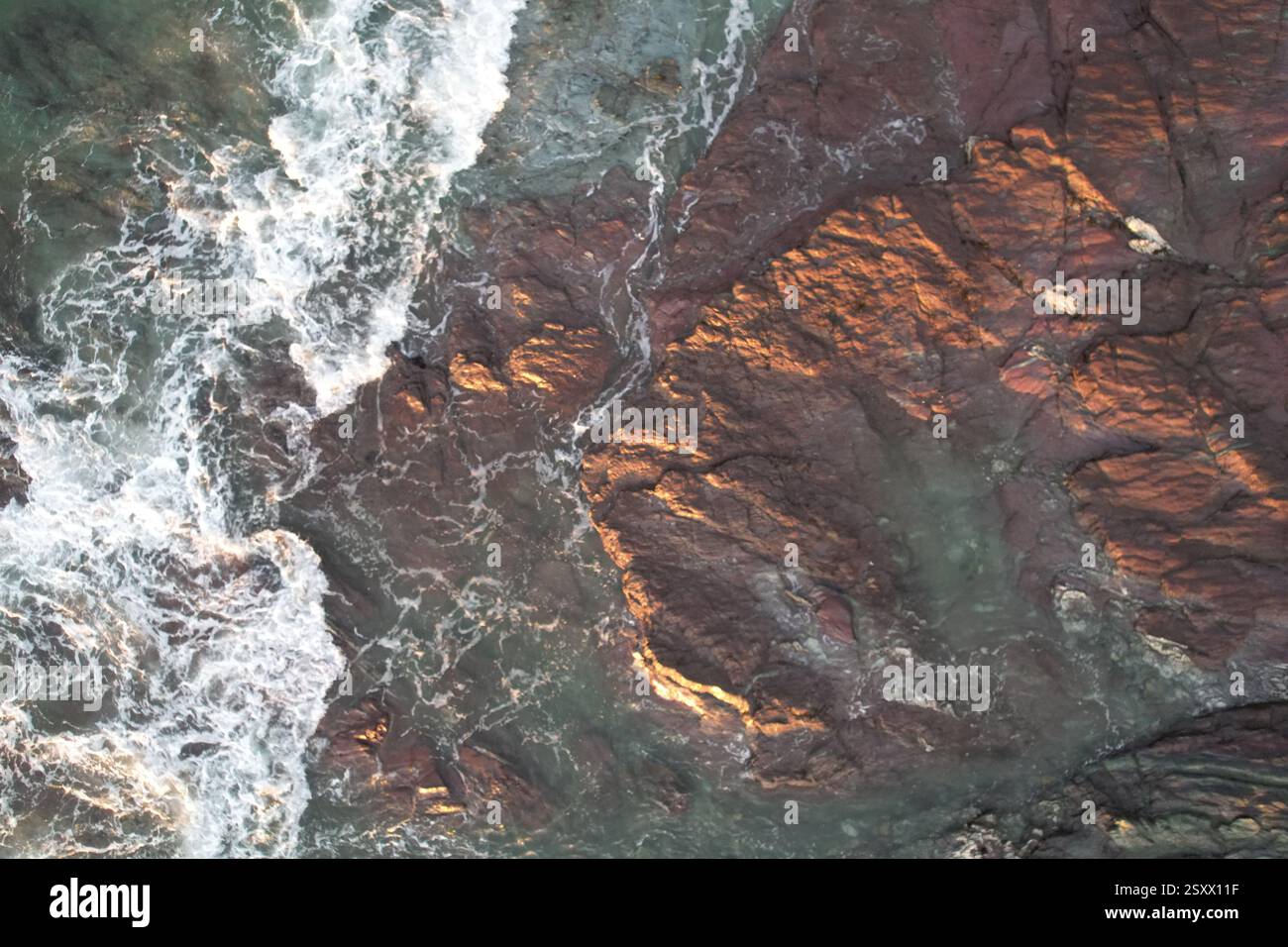 Aerial captures at the shoreline of Downderry beach in Cornwall UK ...