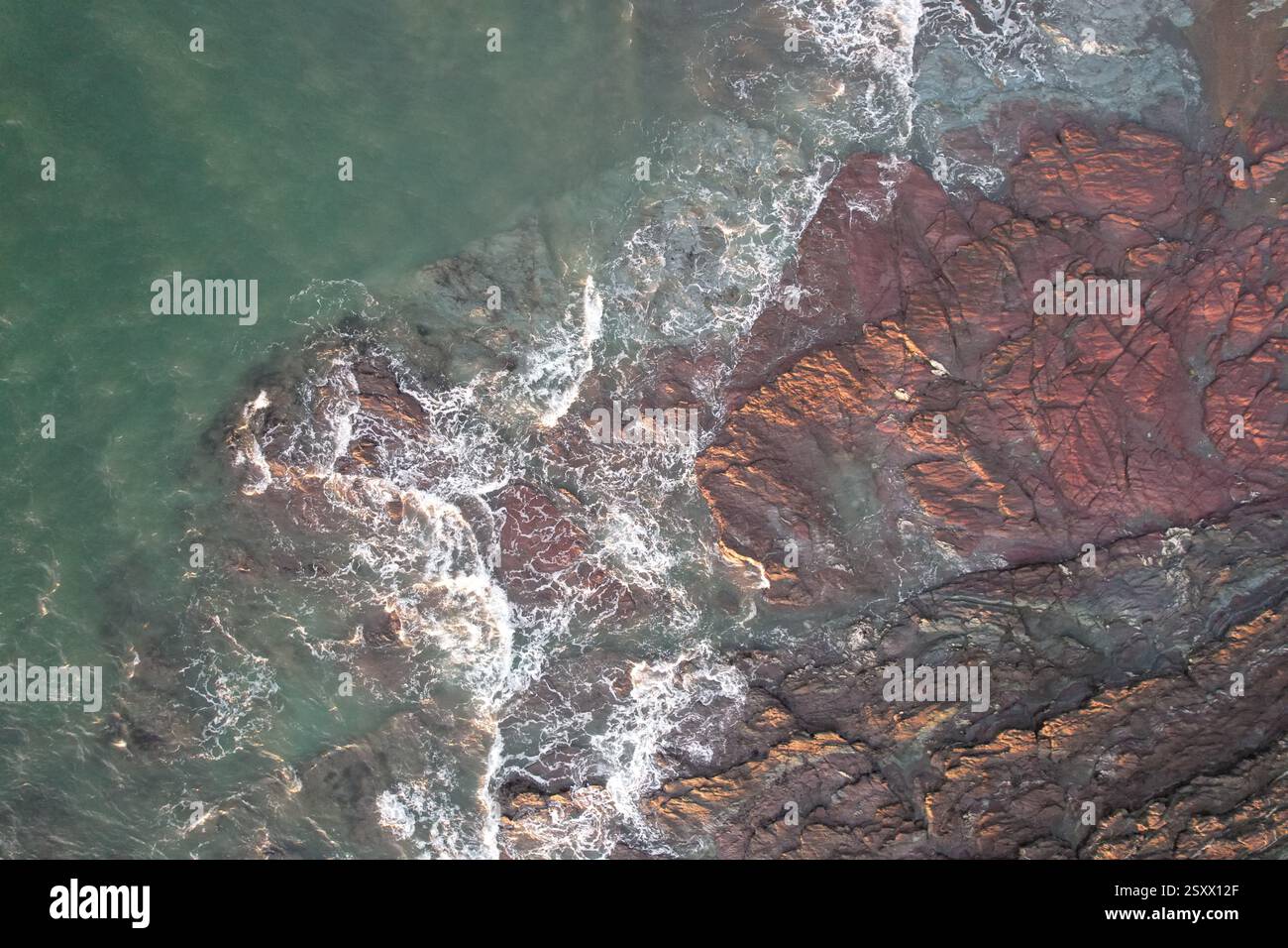 Aerial captures at the shoreline of Downderry beach in Cornwall UK ...