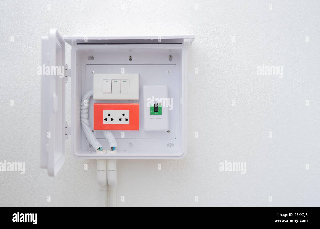 Set of old electrical, socket switch installed at white wall outside ...