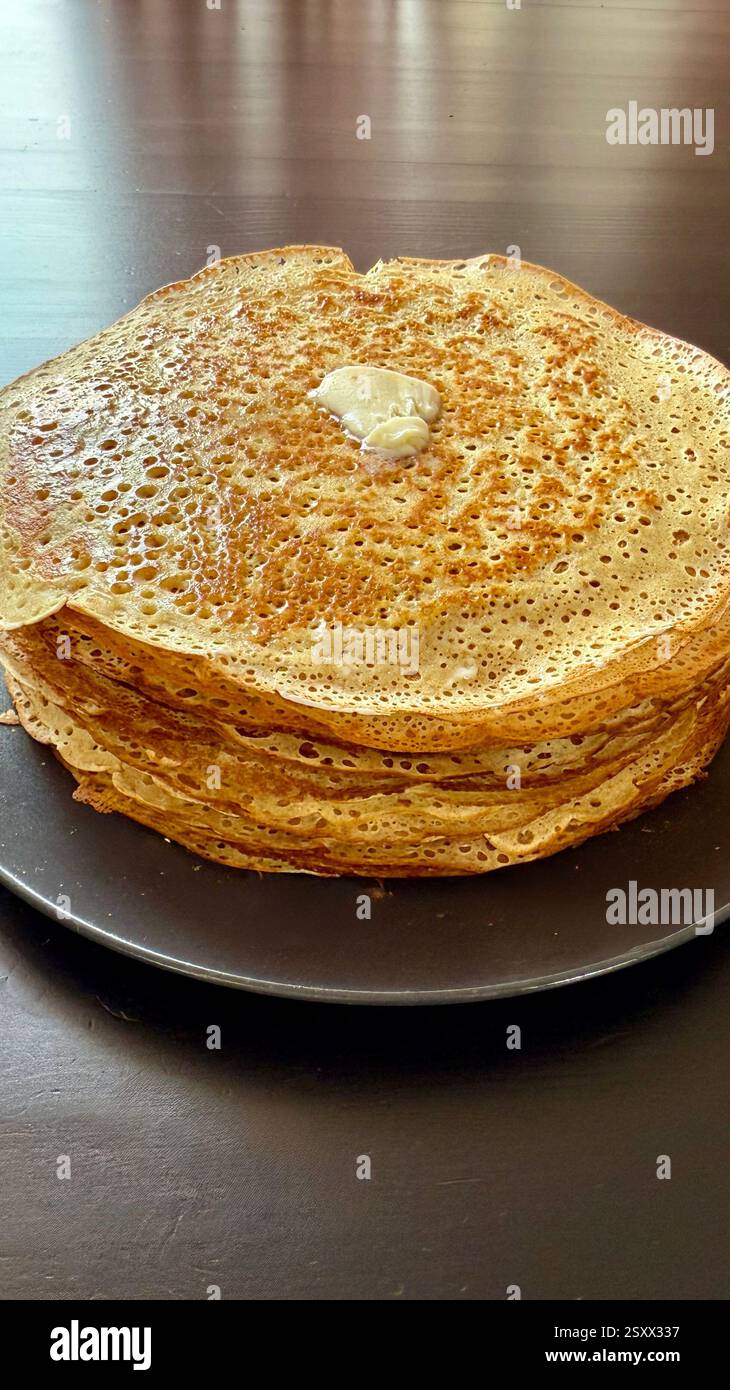 Cooking pancakes. woman's hand holds a pancake, showing off its ...