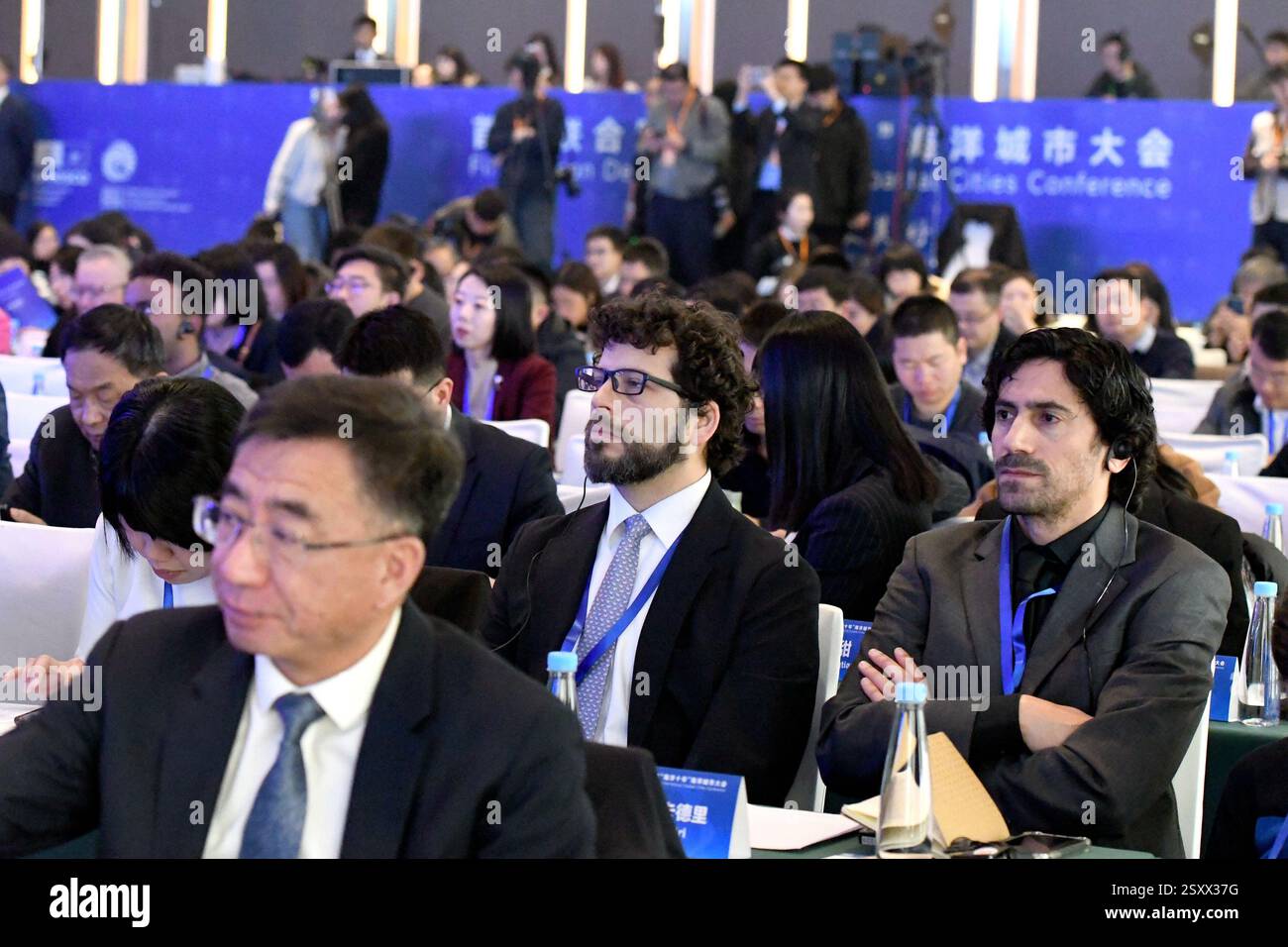 QINGDAO, CHINA - FEBRUARY 26, 2025 - Guests listen carefully to the ...