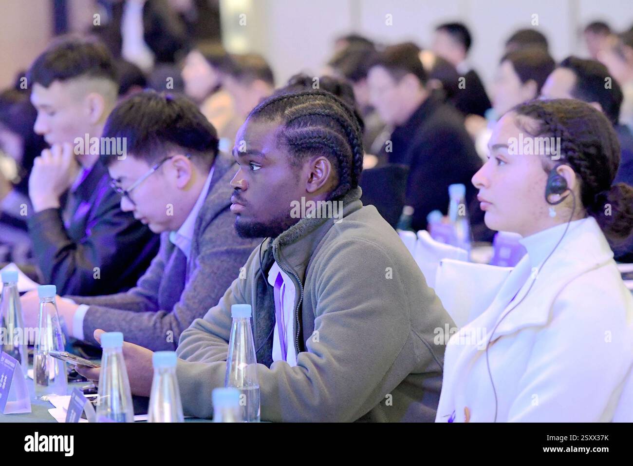 QINGDAO, CHINA - FEBRUARY 26, 2025 - Guests listen carefully to the ...