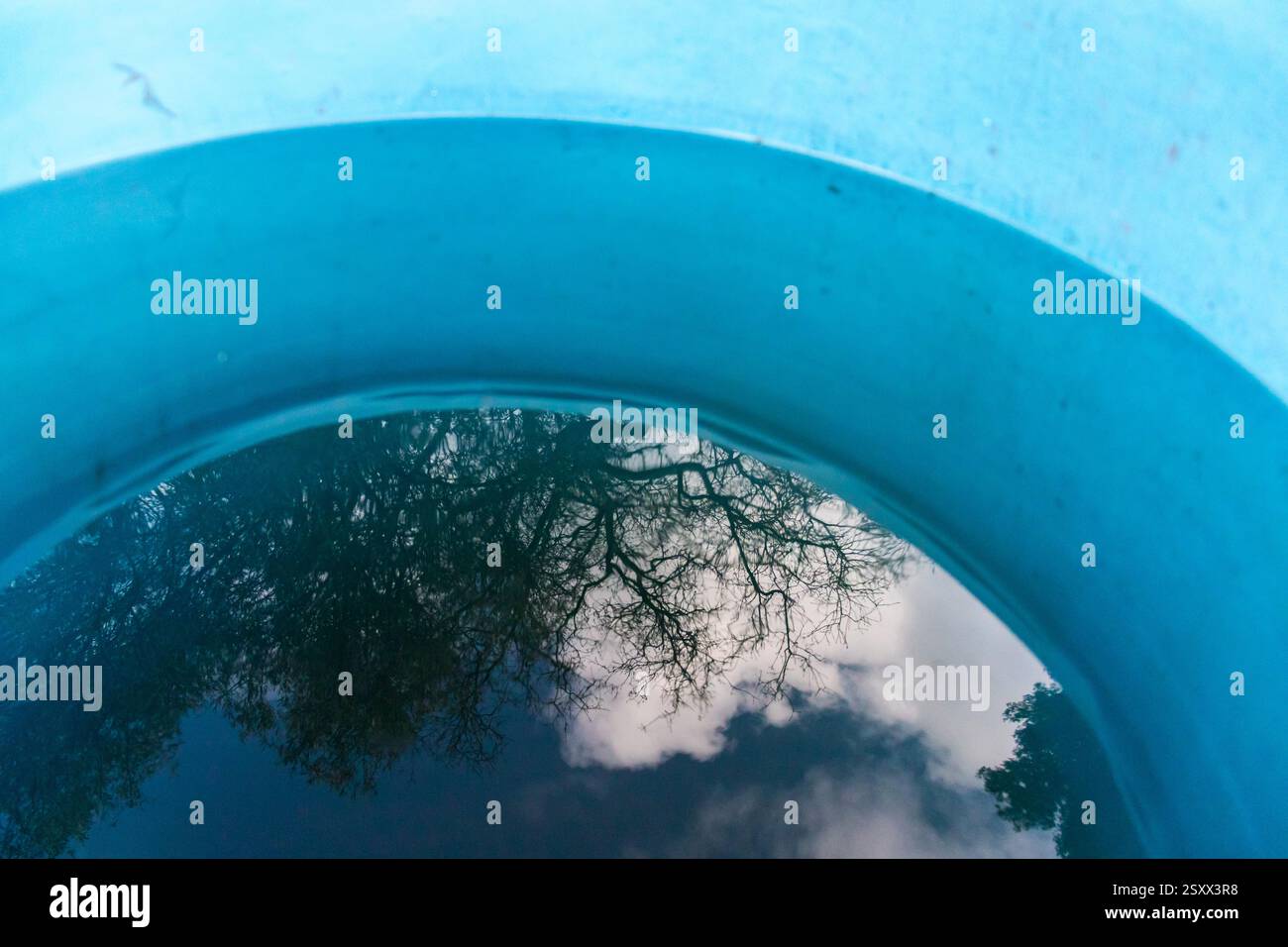 Reflections of water inside a barrel. Water at the bottom of a barrel ...