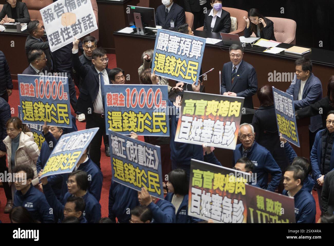 Taiwan opposition party Kuomintang lawmakers hold placards and chant to ...