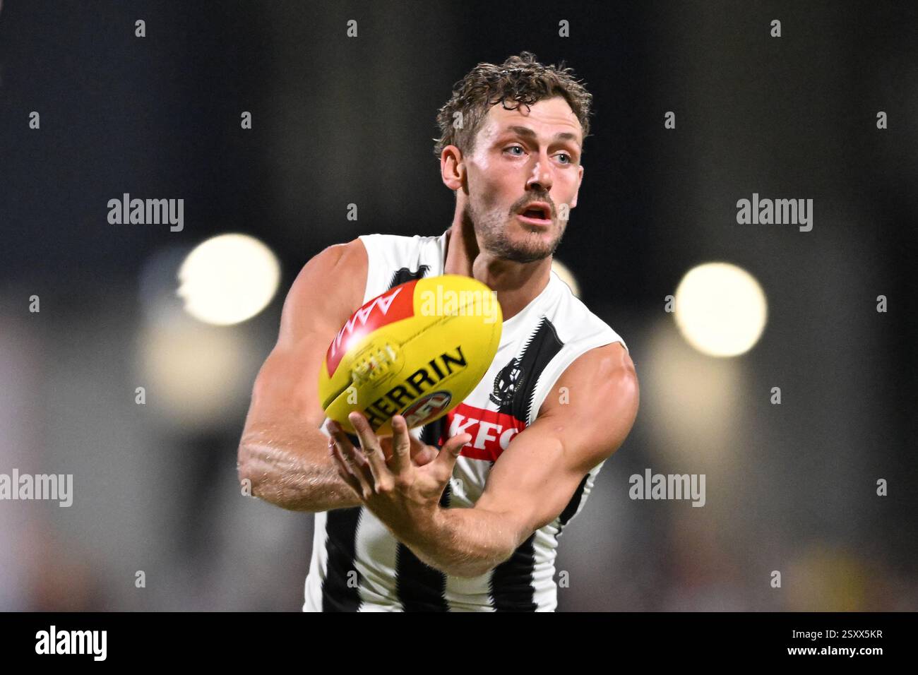 Harry Perryman of Collingwood handballs the footy during the AFL ...