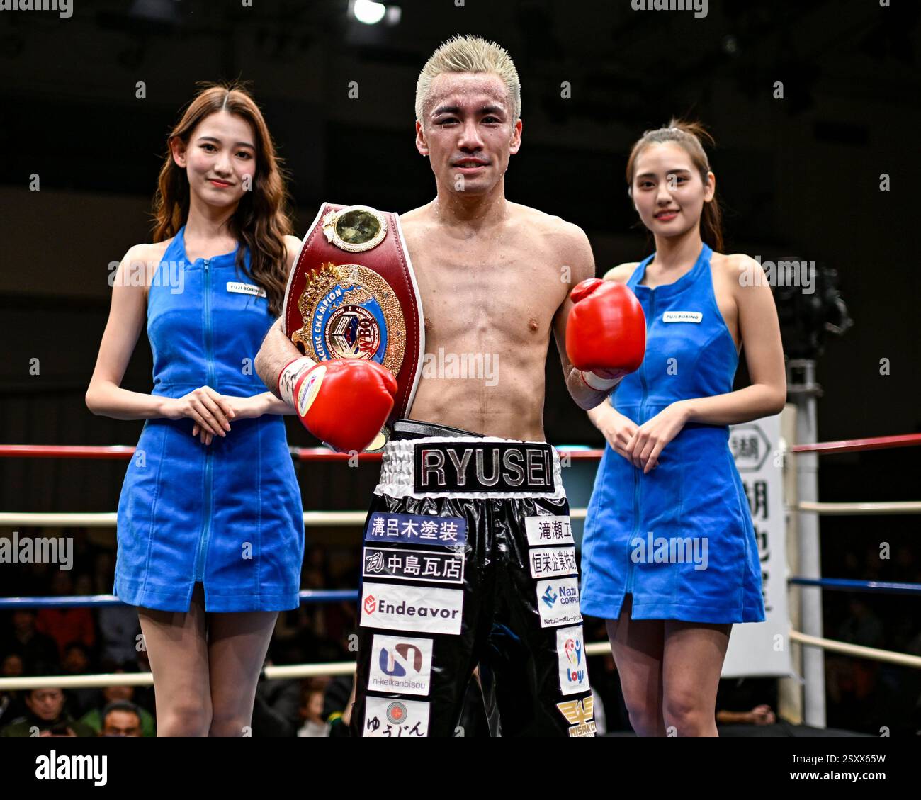 Tokyo, Japan. 11th Feb, 2025. Champion Ryusei Kawaura, center, poses with ring girls Rena Kuroki ...