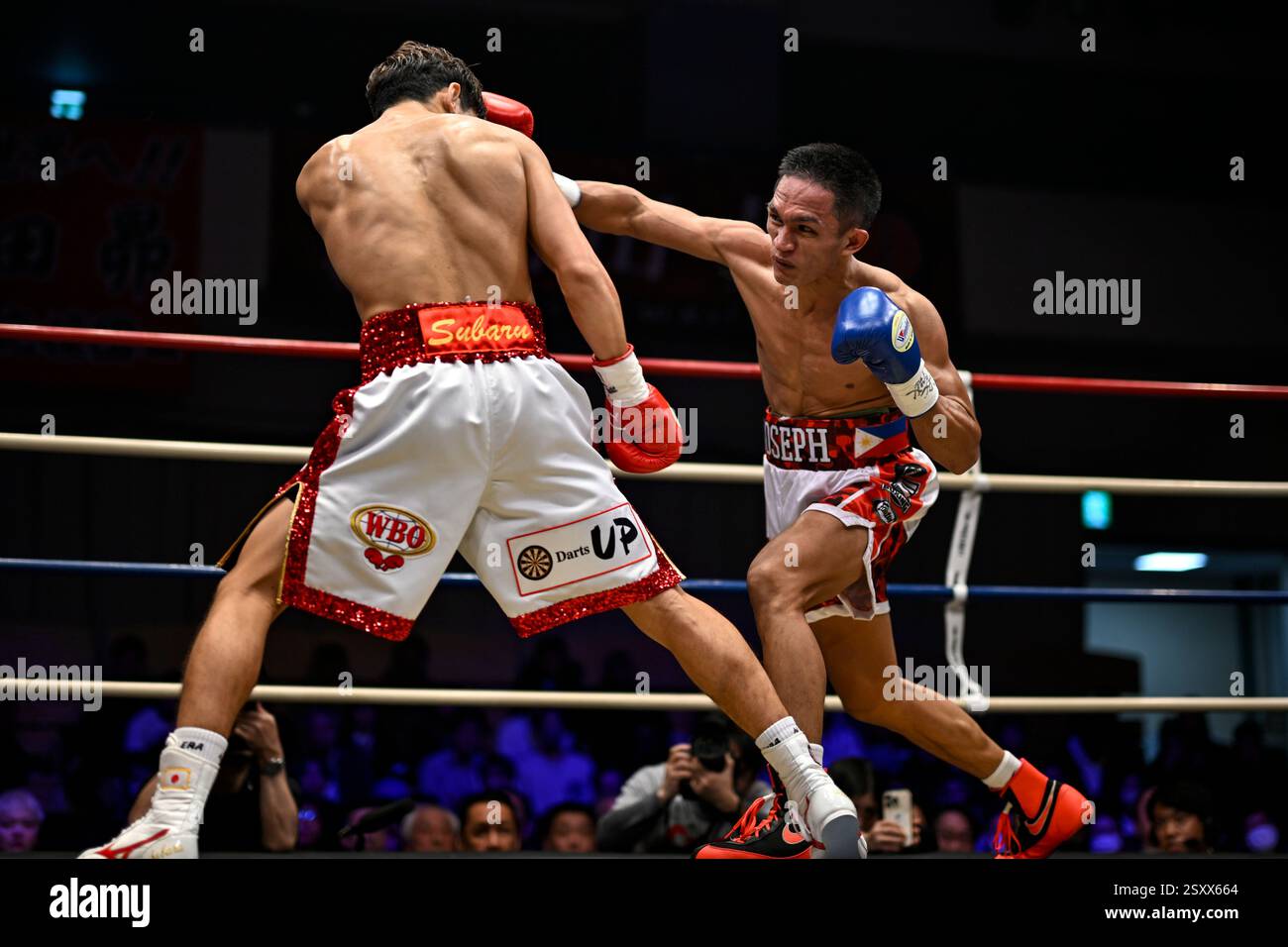 Tokyo, Japan. 1st Feb, 2025. Challenger Philippines' Joseph Ambo (blue gloves) throws a right at ...