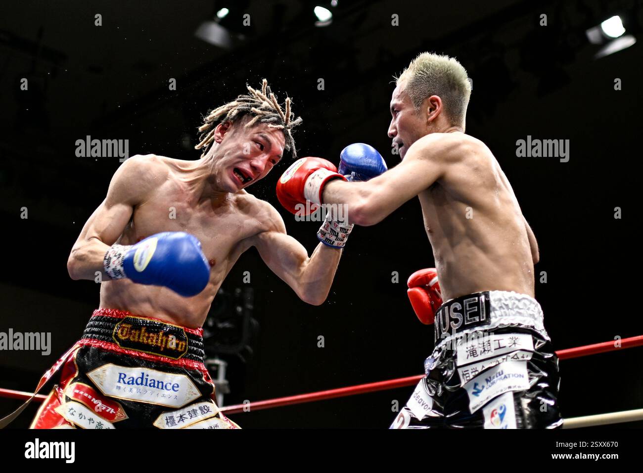 Tokyo, Japan. 11th Feb, 2025. Challenger Takahiro Tai (blue gloves) throws a left at champion ...