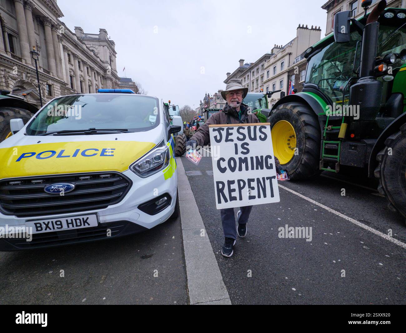 Street preacher passing out religious pamphlets while holding poster ...