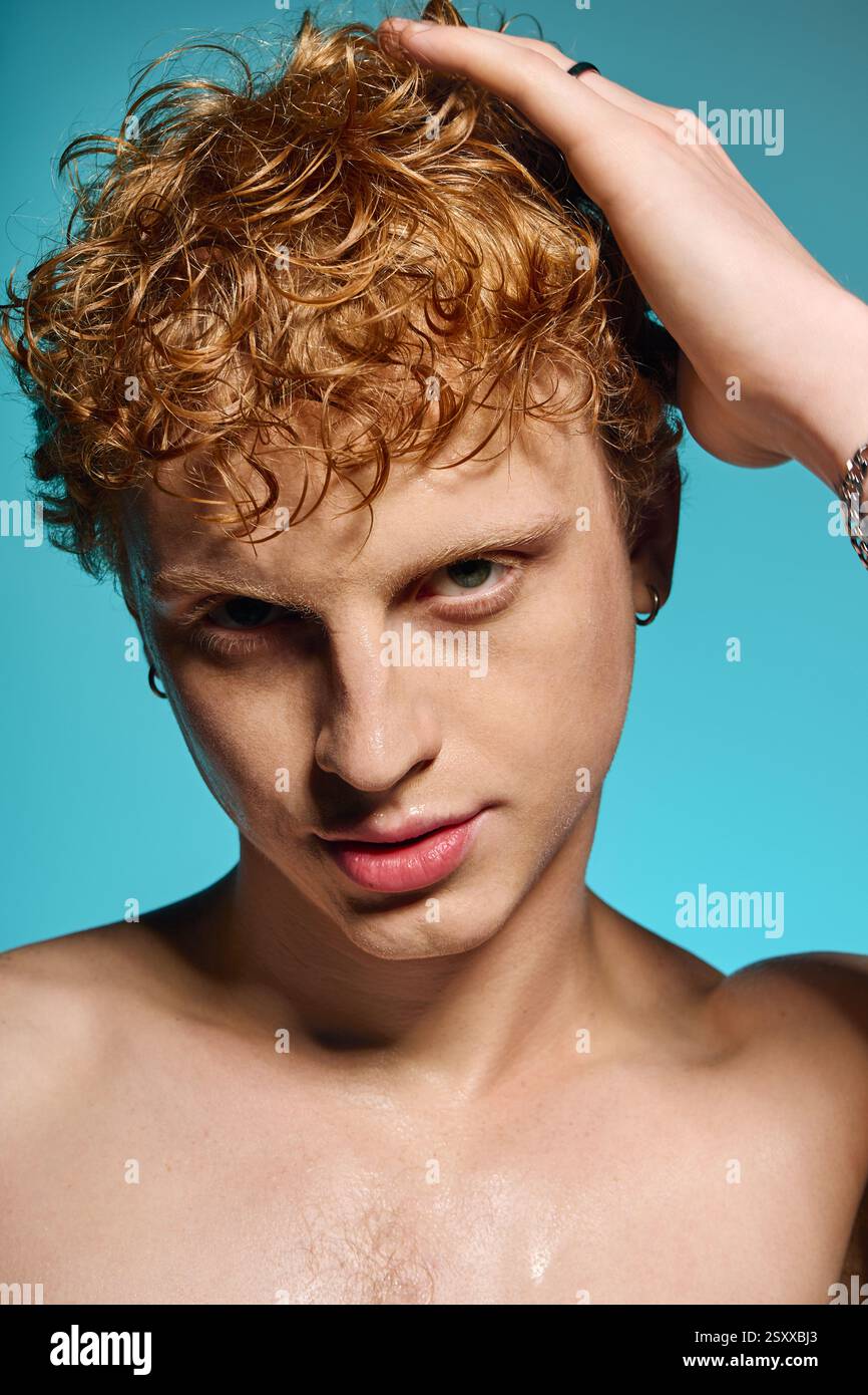 A stylish young man poses confidently, his curly hair framing a ...
