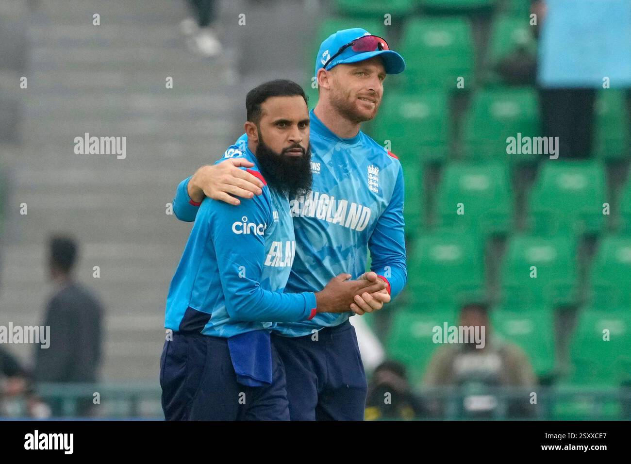 England's Adil Rashid, left, celebrates with Jos Buttler after taking ...