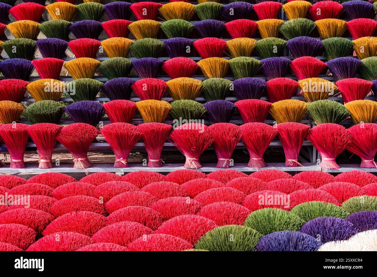Dyed thin bamboo sticks in bundles in various colours for the ...