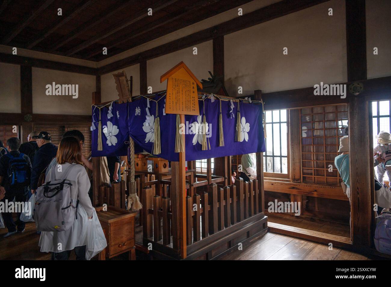 Tourists inside the Himeji Castle, a hilltop Japanese castle complex ...