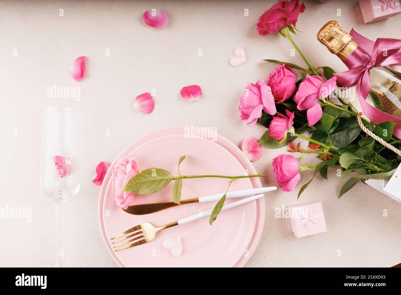 Romantic celebration with pink roses, champagne, and heart decorations ...