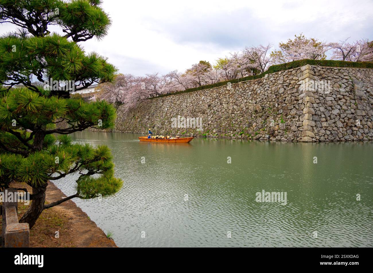Japanese tourist boat riding along the castle moat in front of the ...