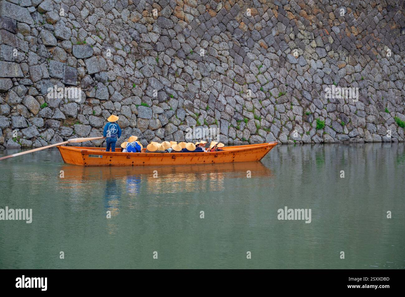 Japanese tourist boat riding along the castle moat in front of the ...