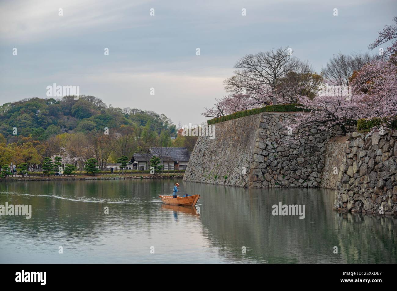 Japanese tourist boat riding along the castle moat in front of the ...