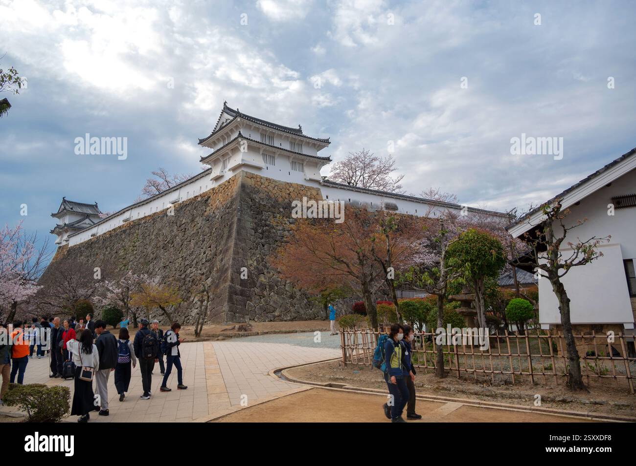 Tourists inside the Himeji Castle, a hilltop Japanese castle complex ...