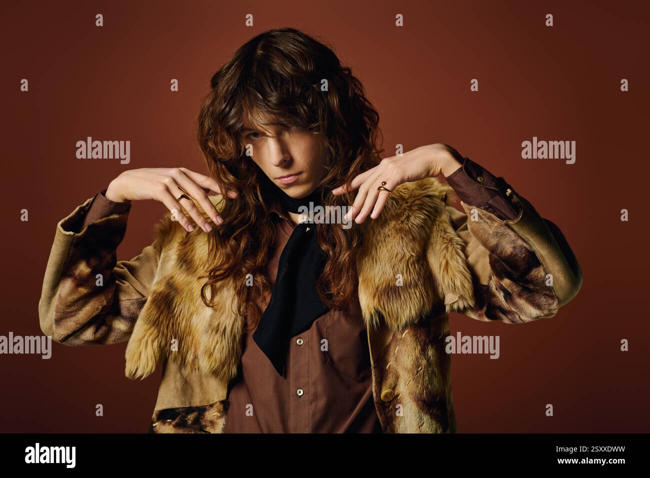 A stylish young man with long hair flaunts bold fashion with fur ...