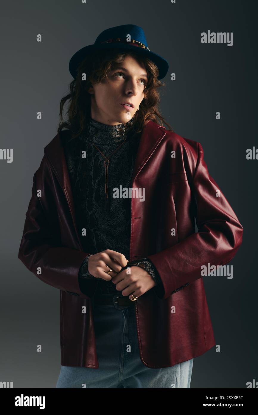 A handsome young man poses confidently in a fashionable leather jacket ...