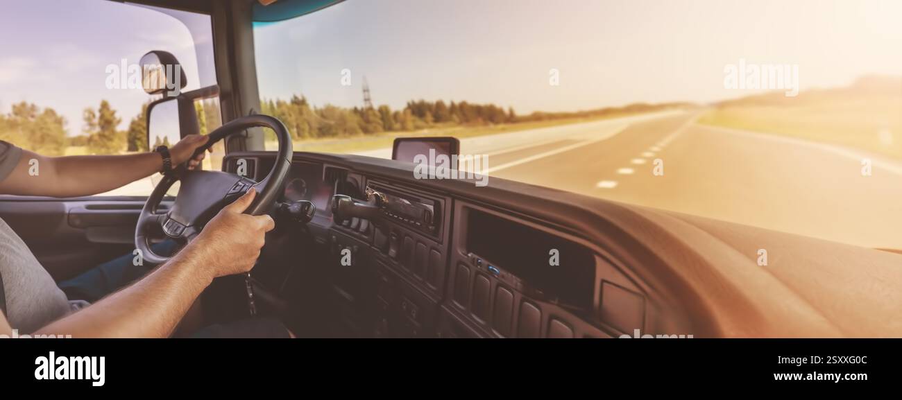 Truck driver sitting behind the wheel and driving a vehicle Stock Photo ...