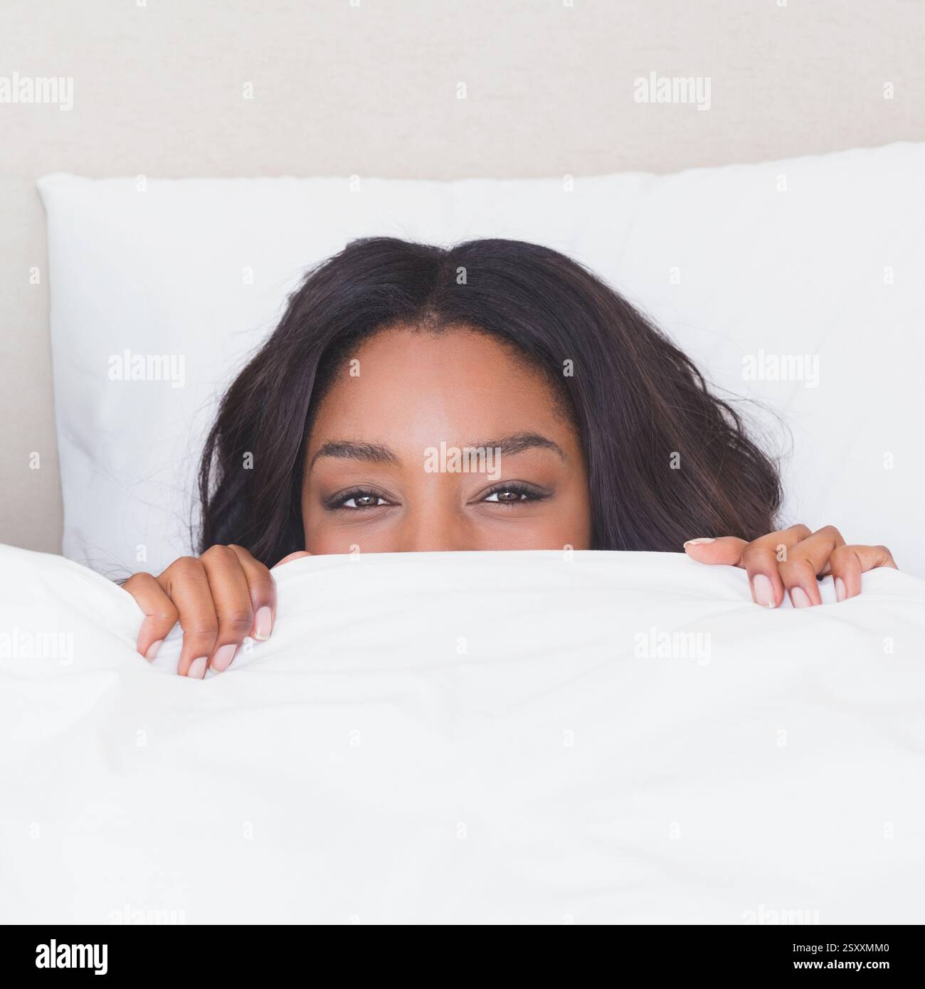 Woman peeking from under blanket hi-res stock photography and images ...