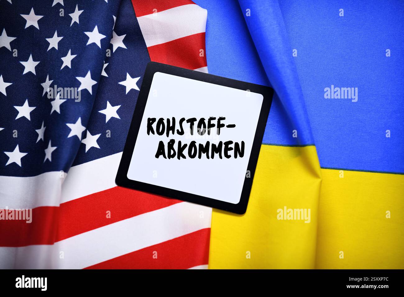 FOTOMONTAGE, Die Fahnen der Ukraine und USA mit Tafel und Aufschrift ...