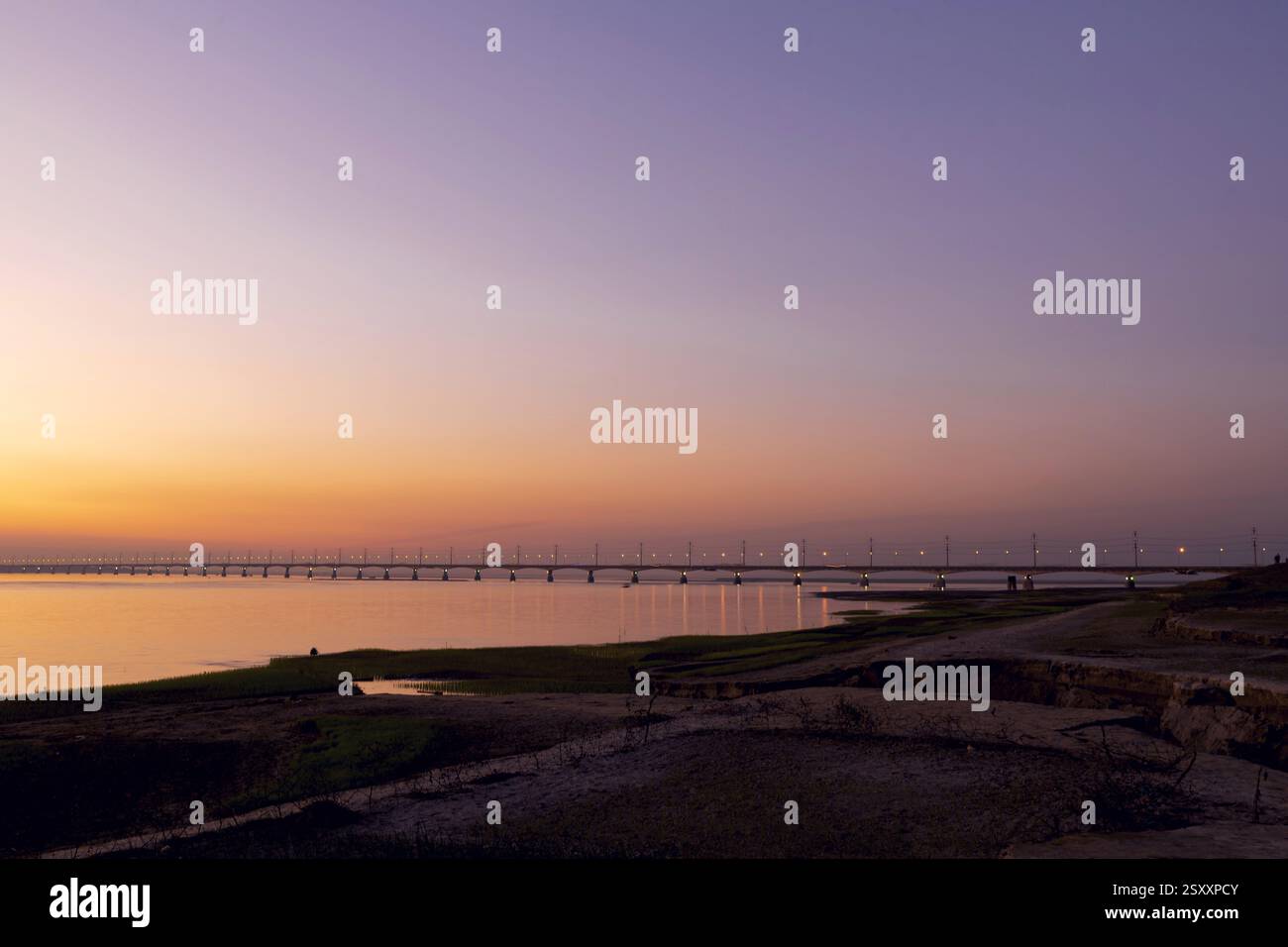 A sunset over the Jamuna River offers a breathtaking view, as the sky ...