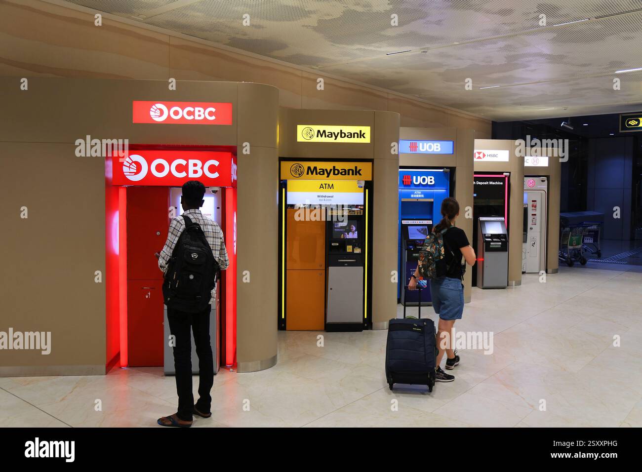 SINGAPORE CITY, SINGAPORE - MARCH 10, 2024: Passengers visit ATM cash ...