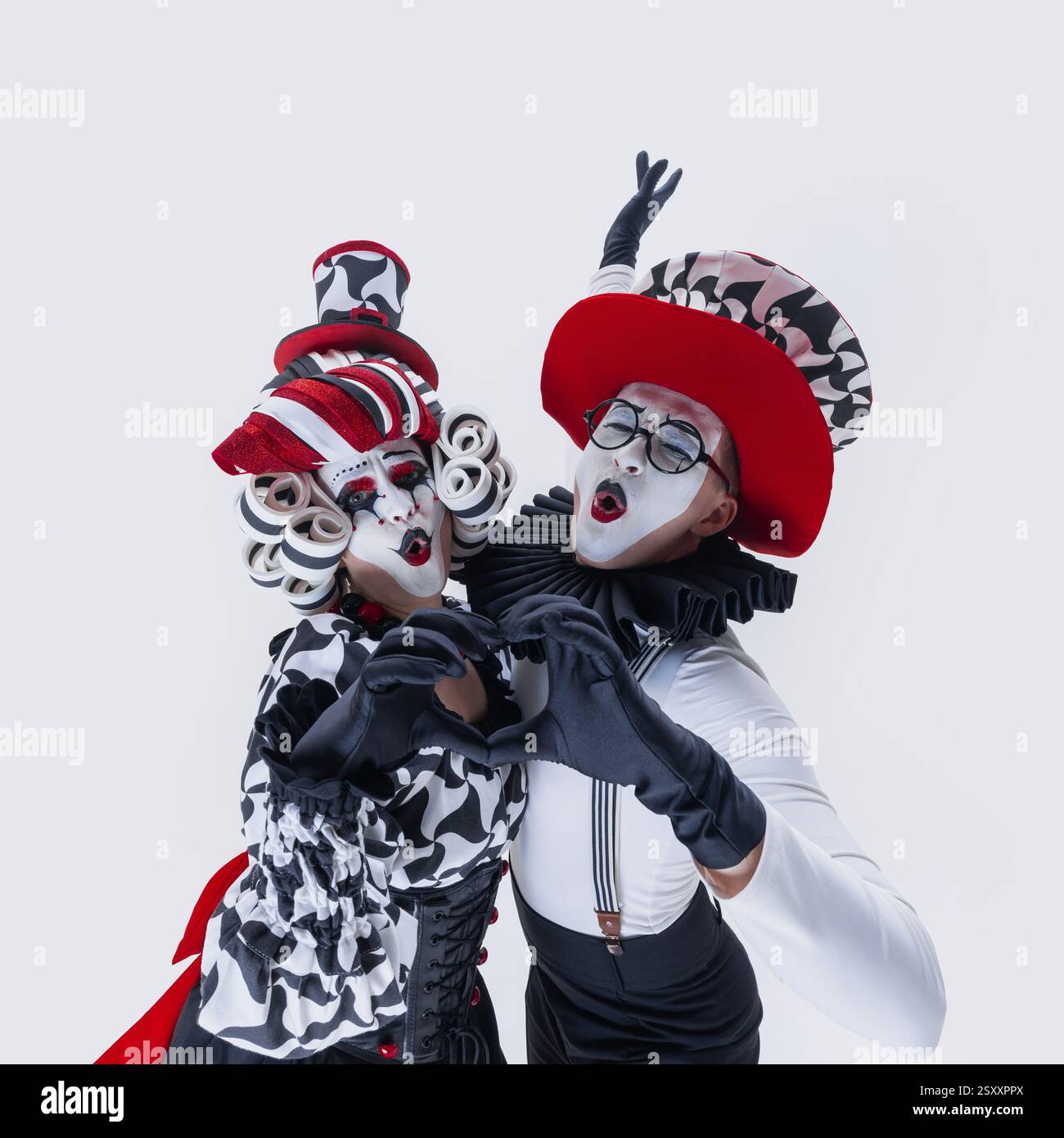 Artistic circus duo, man and woman in stylish costumes performing ...