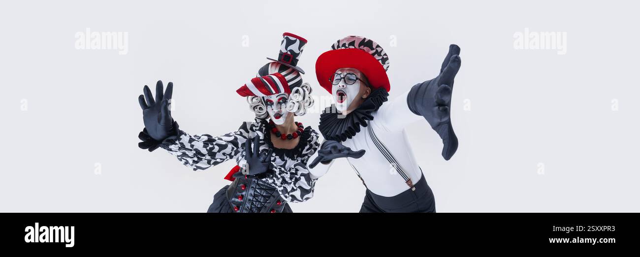 Artistic circus duo, man and woman in stylish costumes performing ...