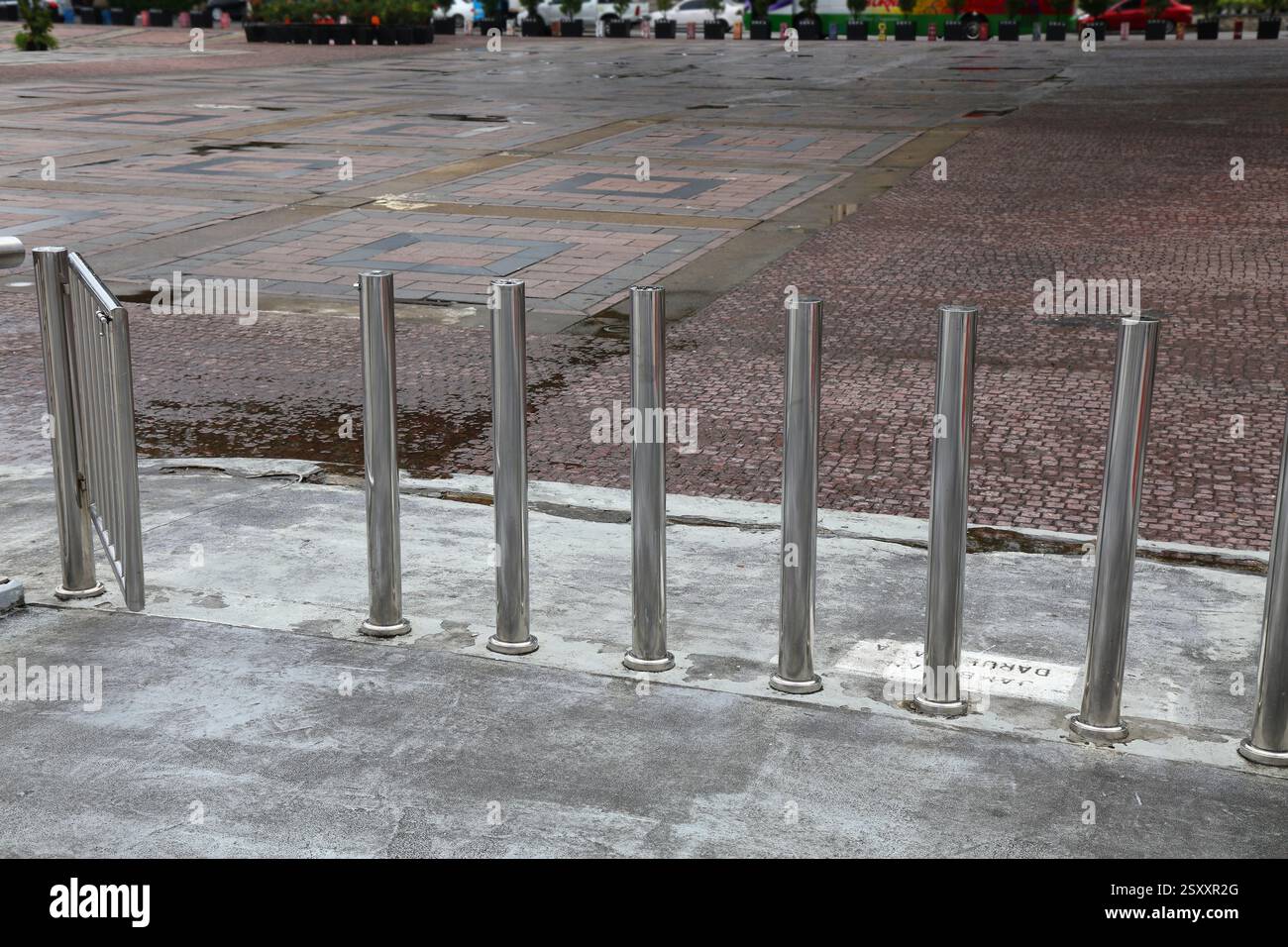 Pedestrian walkway in Kuching city, Malaysia. Steel pole barrier ...