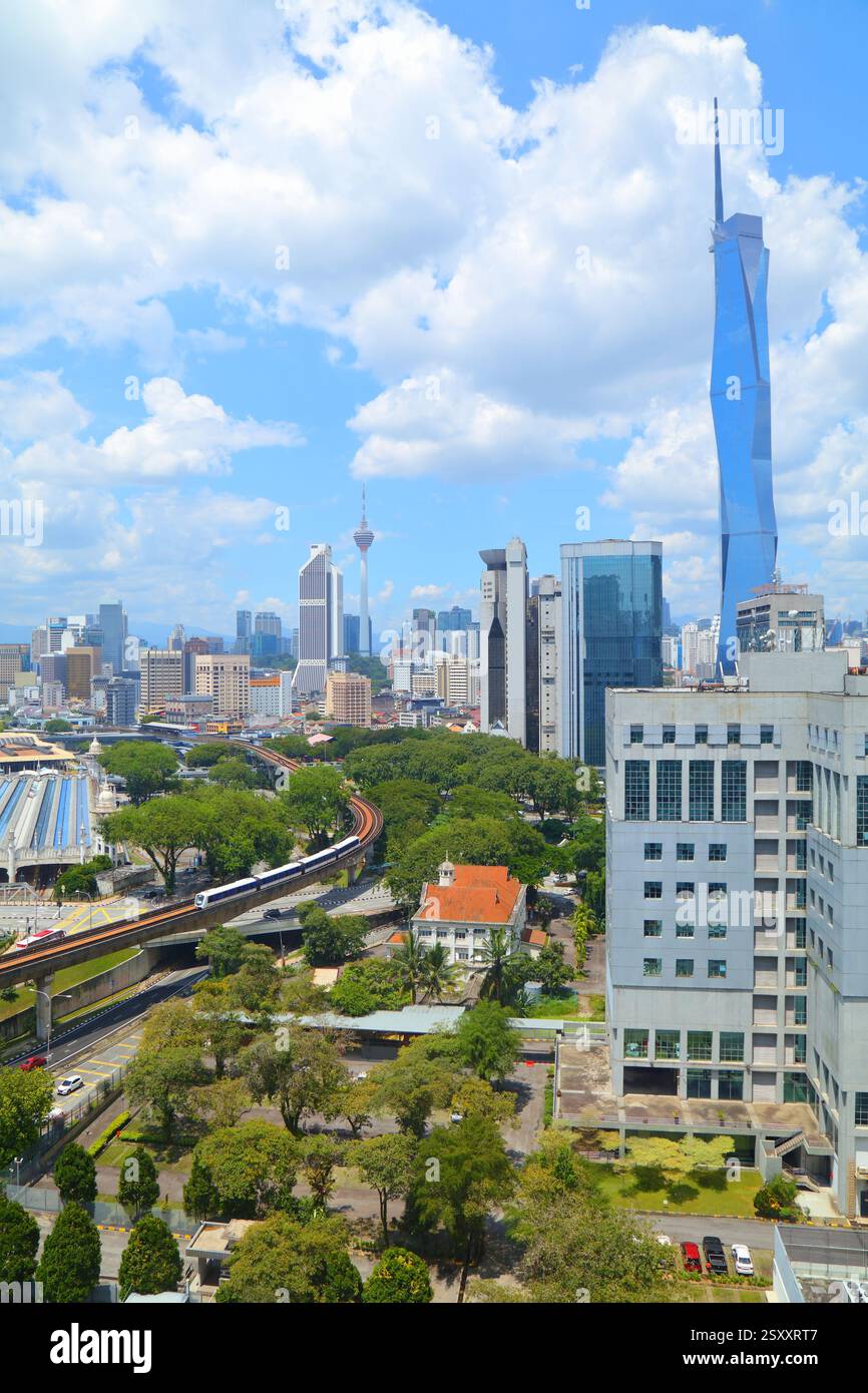 Kuala Lumpur city skyline with LRT public transportation train in ...