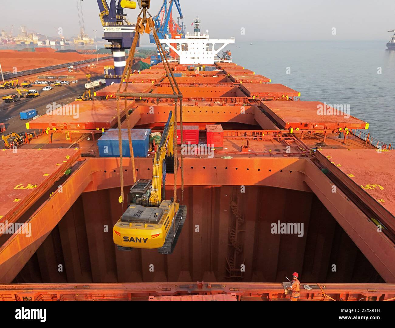 Yantai, China. 26th Feb, 2025. Excavators exported to Guinea are loaded ...